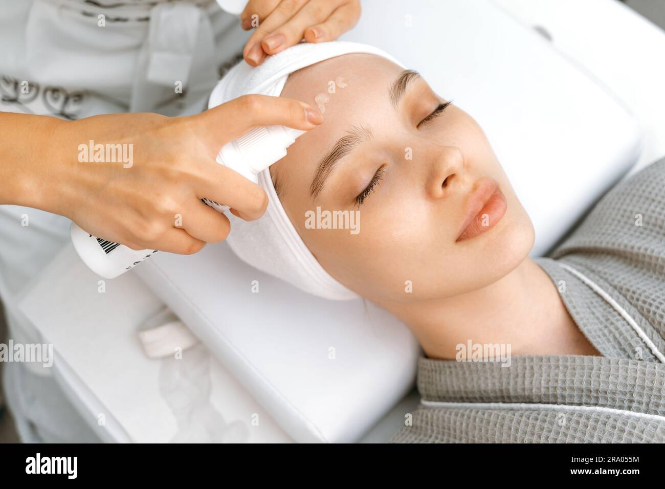 Beauty concept. Salon procedures. Applying gel on the face of a ...