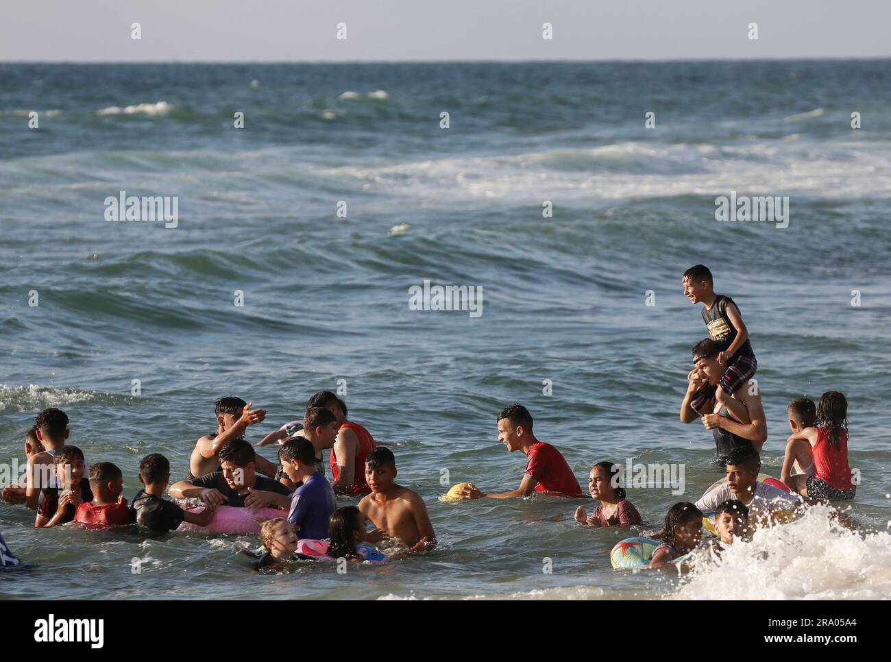 Palestinians seen bathing at the beach in the Mediterranean Sea on the ...