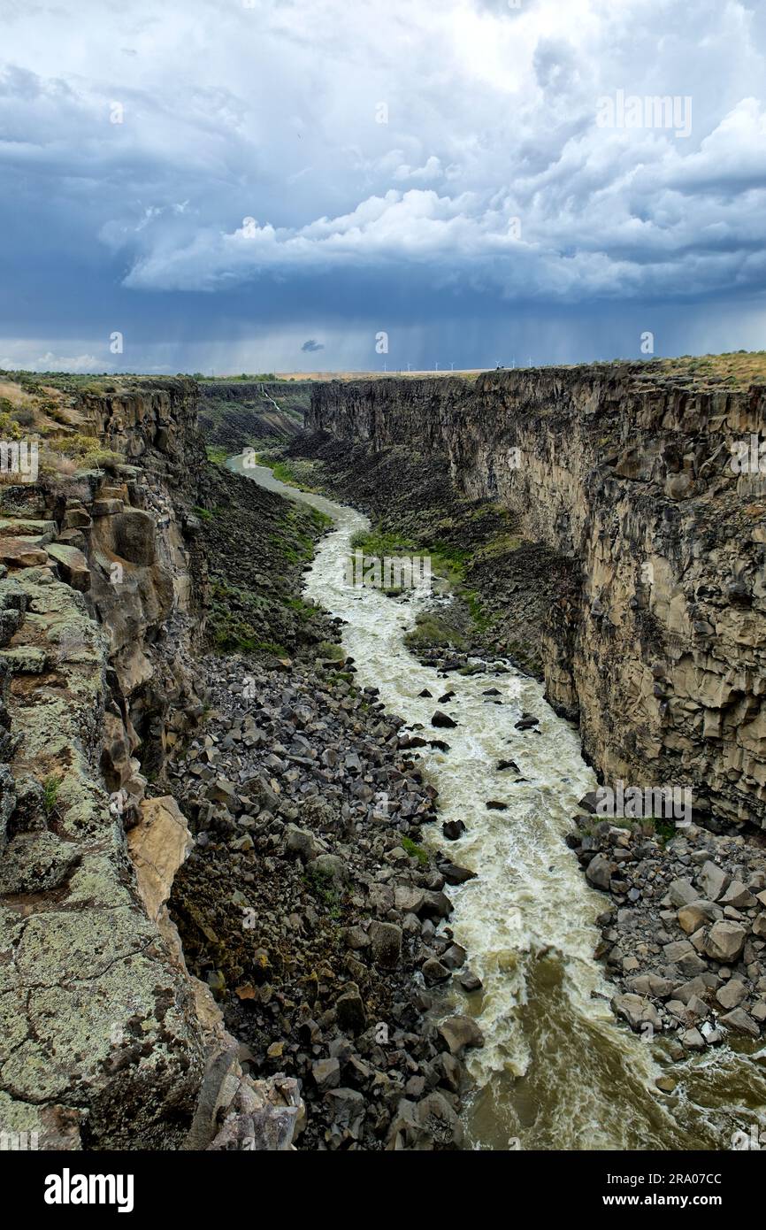 The Malad River winds through the famous Malad Gorge under a dramatic ...