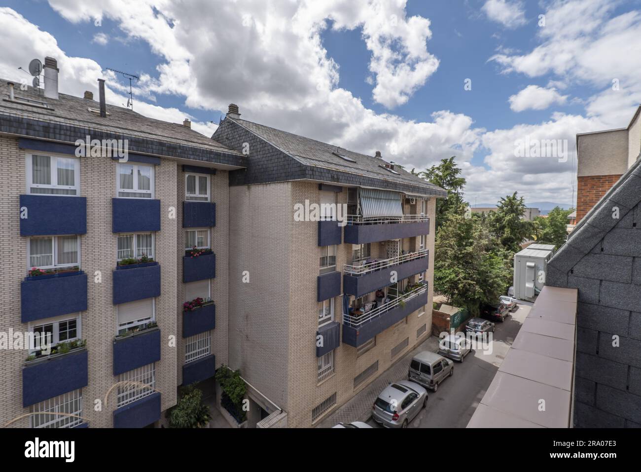 Facades of urban residential buildings with roofs covered with black ...