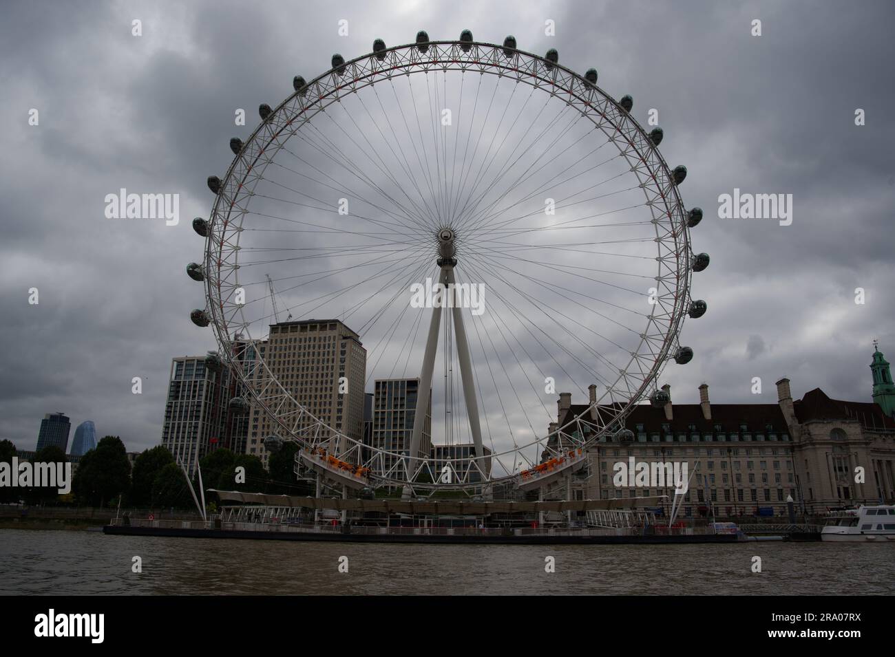 The London Eye observation wheel seen from a boat on the River Thames ...