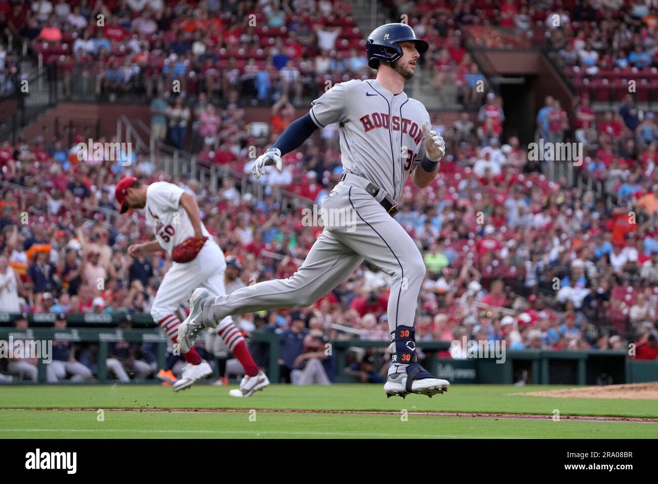 Houston Astros' Kyle Tucker, right, heads to first on a two-run single ...