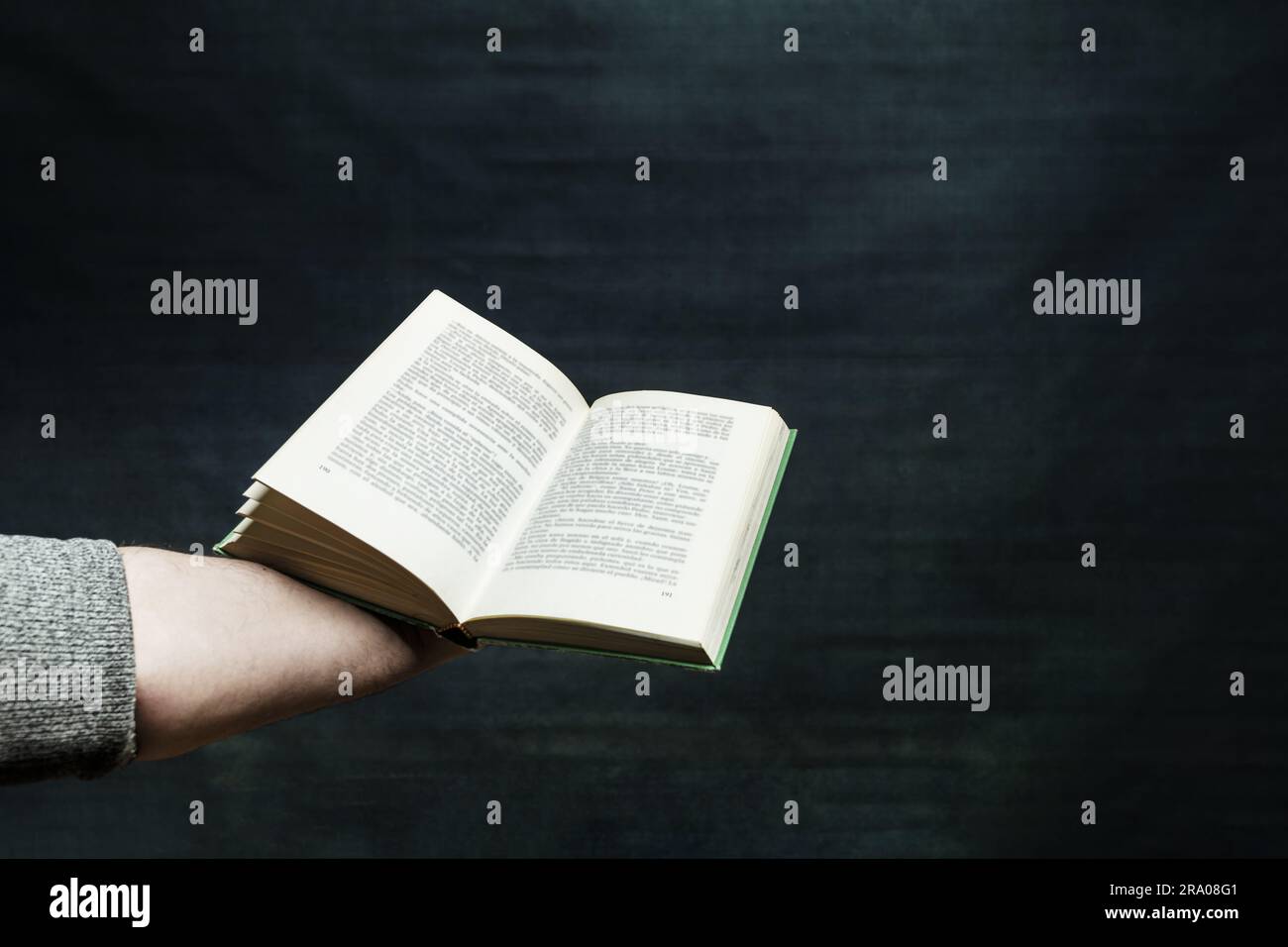 Holding with a hug a book with sheets of paper Stock Photo - Alamy