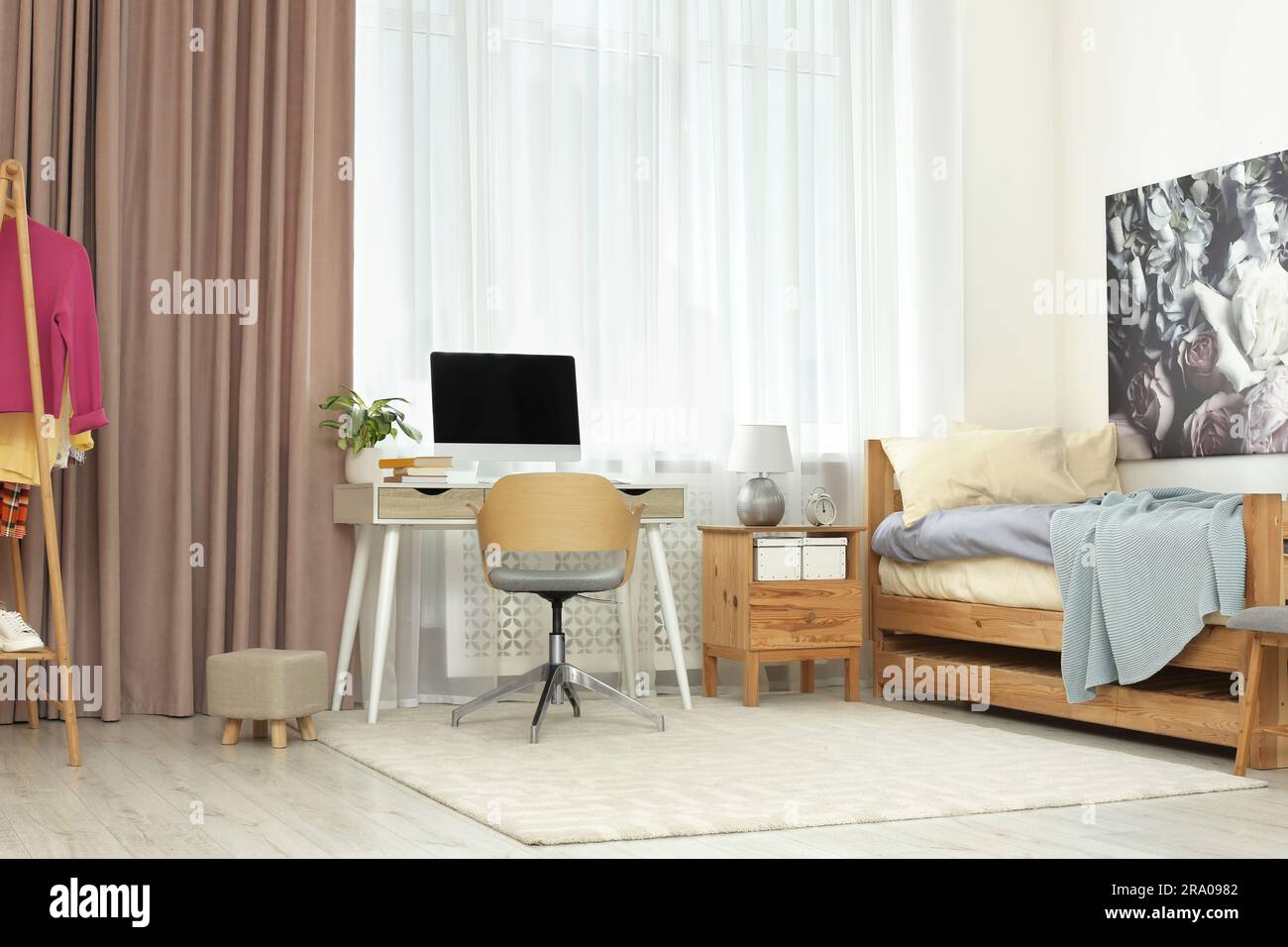 Stylish teenager's room interior with computer and comfortable bed ...