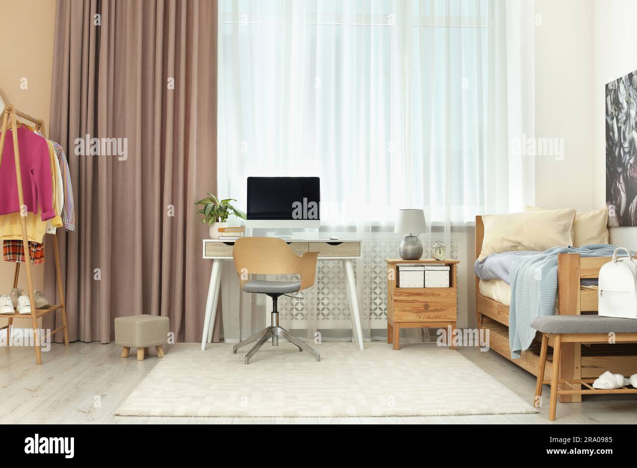 Stylish teenager's room interior with computer and comfortable bed ...