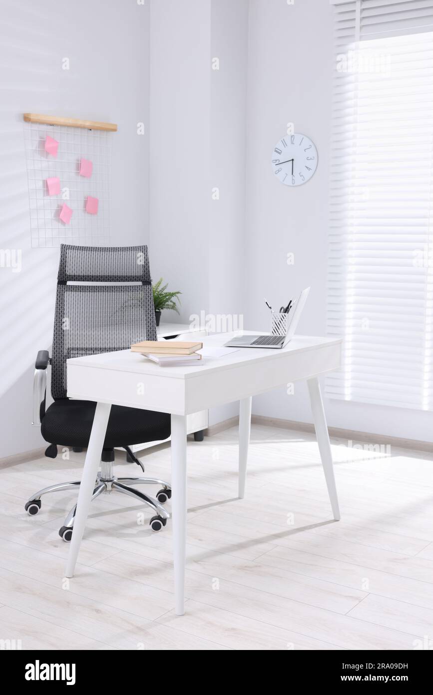 Desk and comfortable chair in modern office. Interior design Stock ...