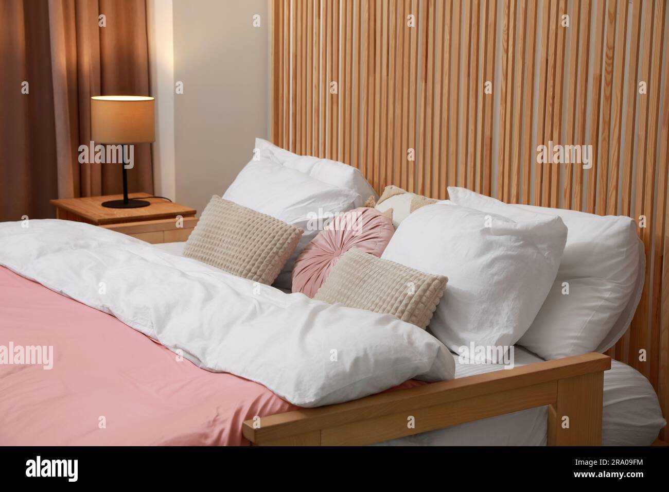 Comfortable bed with cushions in bedroom. Interior design Stock Photo ...