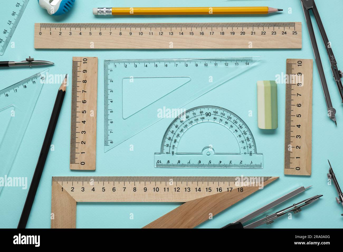 Flat lay composition with different rulers and protractor on turquoise ...