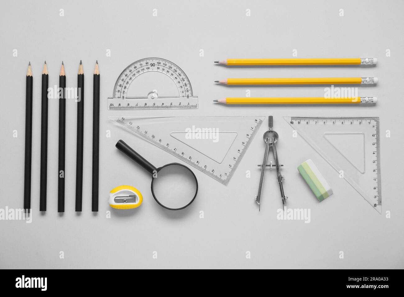 Flat lay composition with different rulers and compass on light grey ...