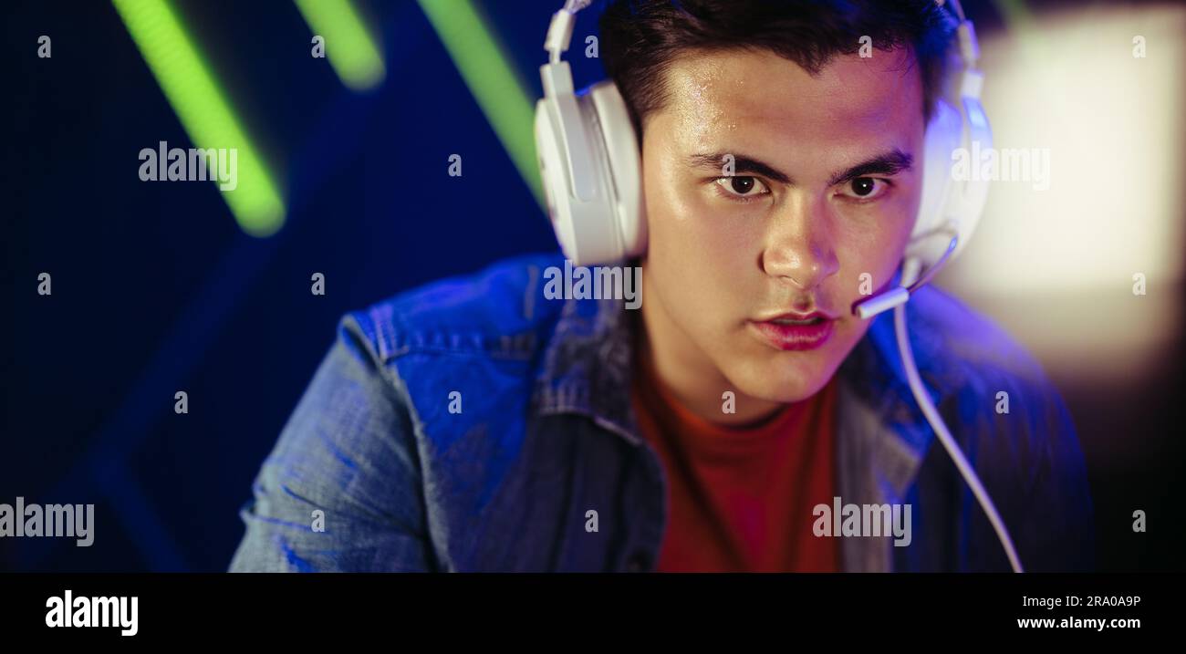 Focusing on his computer screen, a male gamer engages in an online ...