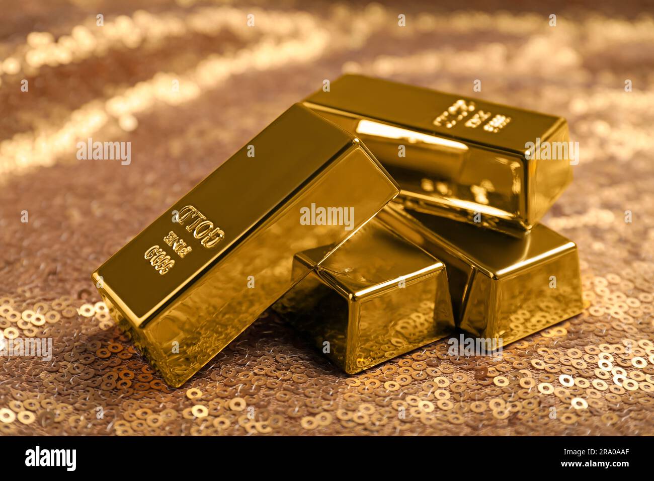 Shiny gold bars on bronze sequin fabric, closeup Stock Photo - Alamy
