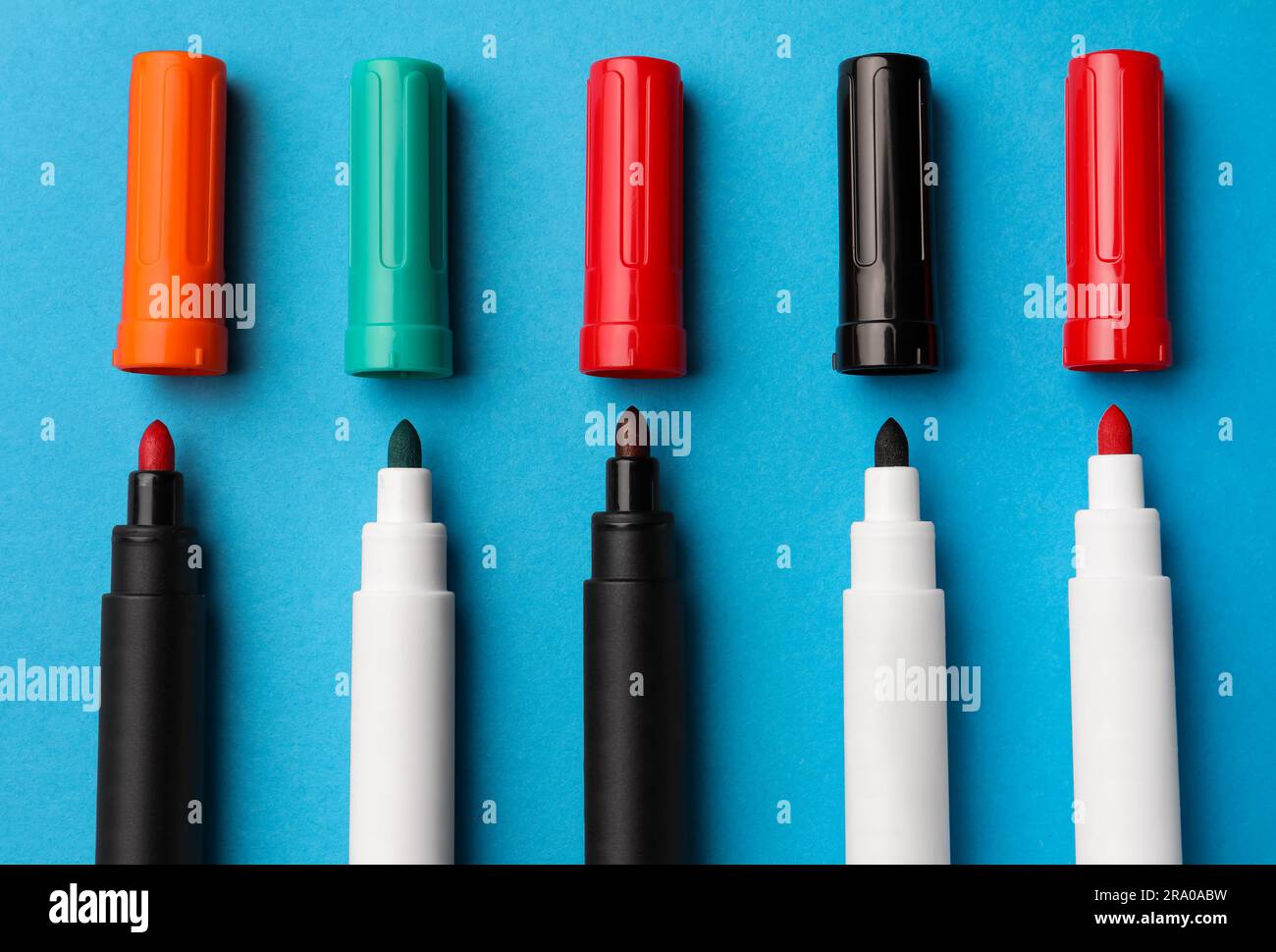 Bright color markers on light blue background, flat lay Stock Photo - Alamy