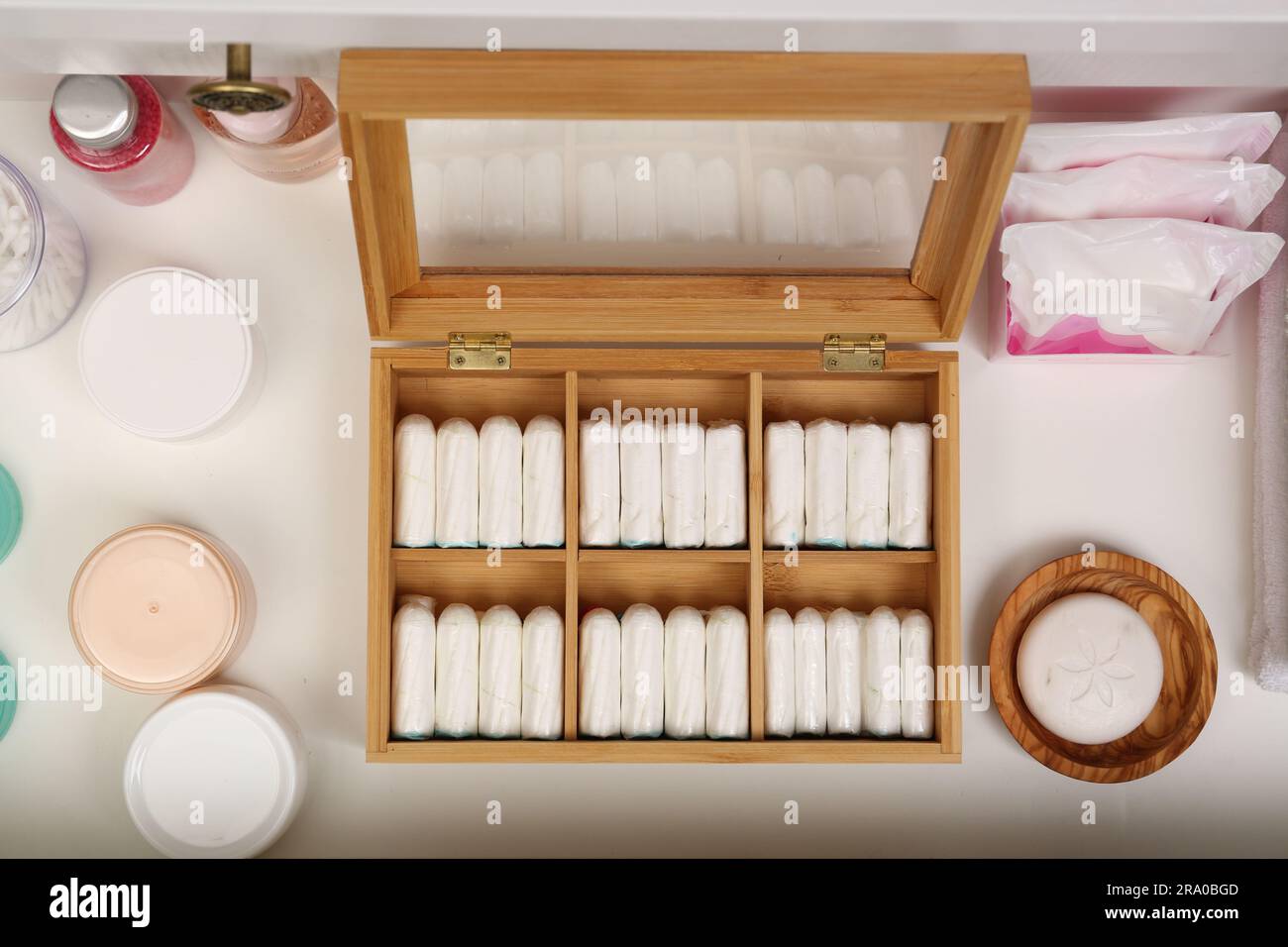 Storage of tampons and different hygiene products in white drawer, flat ...