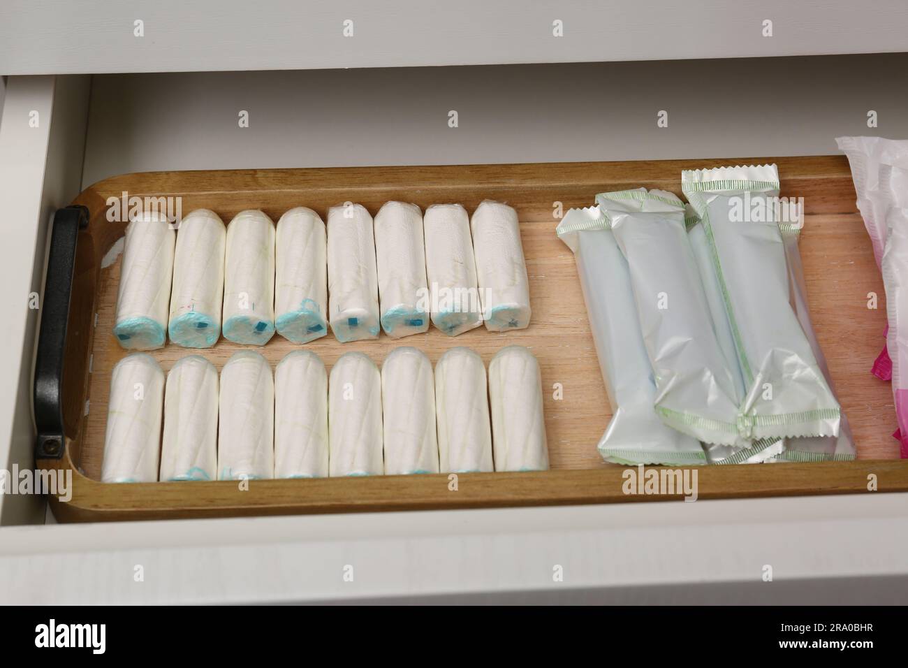 Storage of many different tampons in white drawer. Menstrual hygienic ...