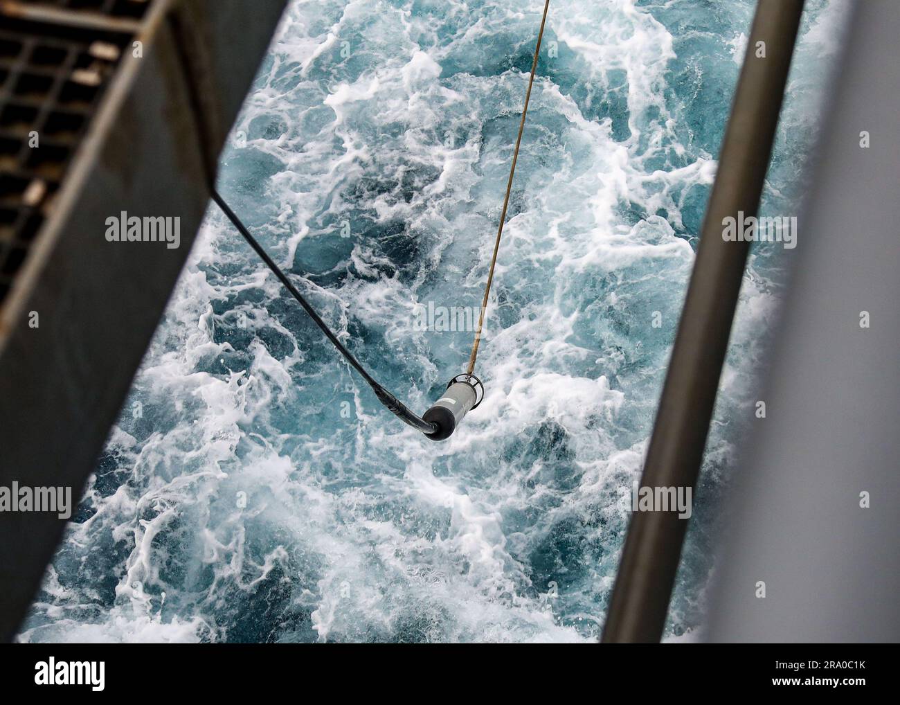 The Nixie system is lowered into the water from the Nimitz-class ...