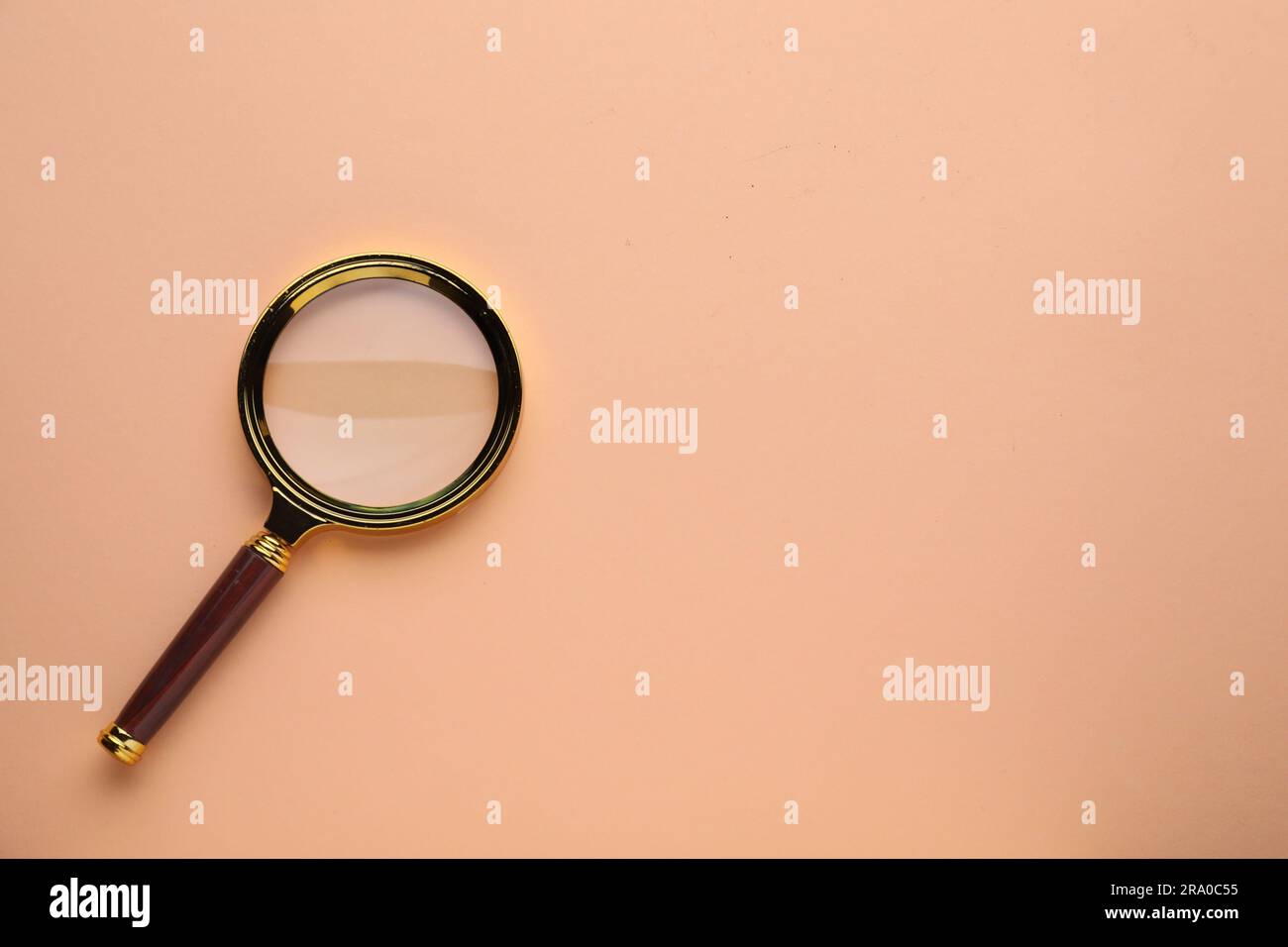 Magnifying glass on beige background, top view. Space for text Stock ...