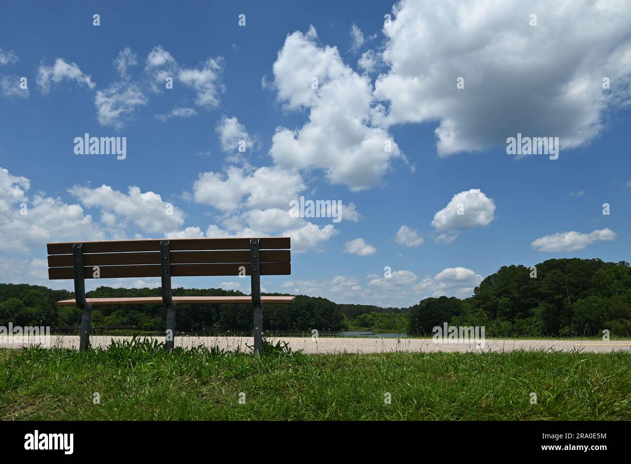 A park bench with a blue sky background in Raleigh, NC Stock Photo - Alamy