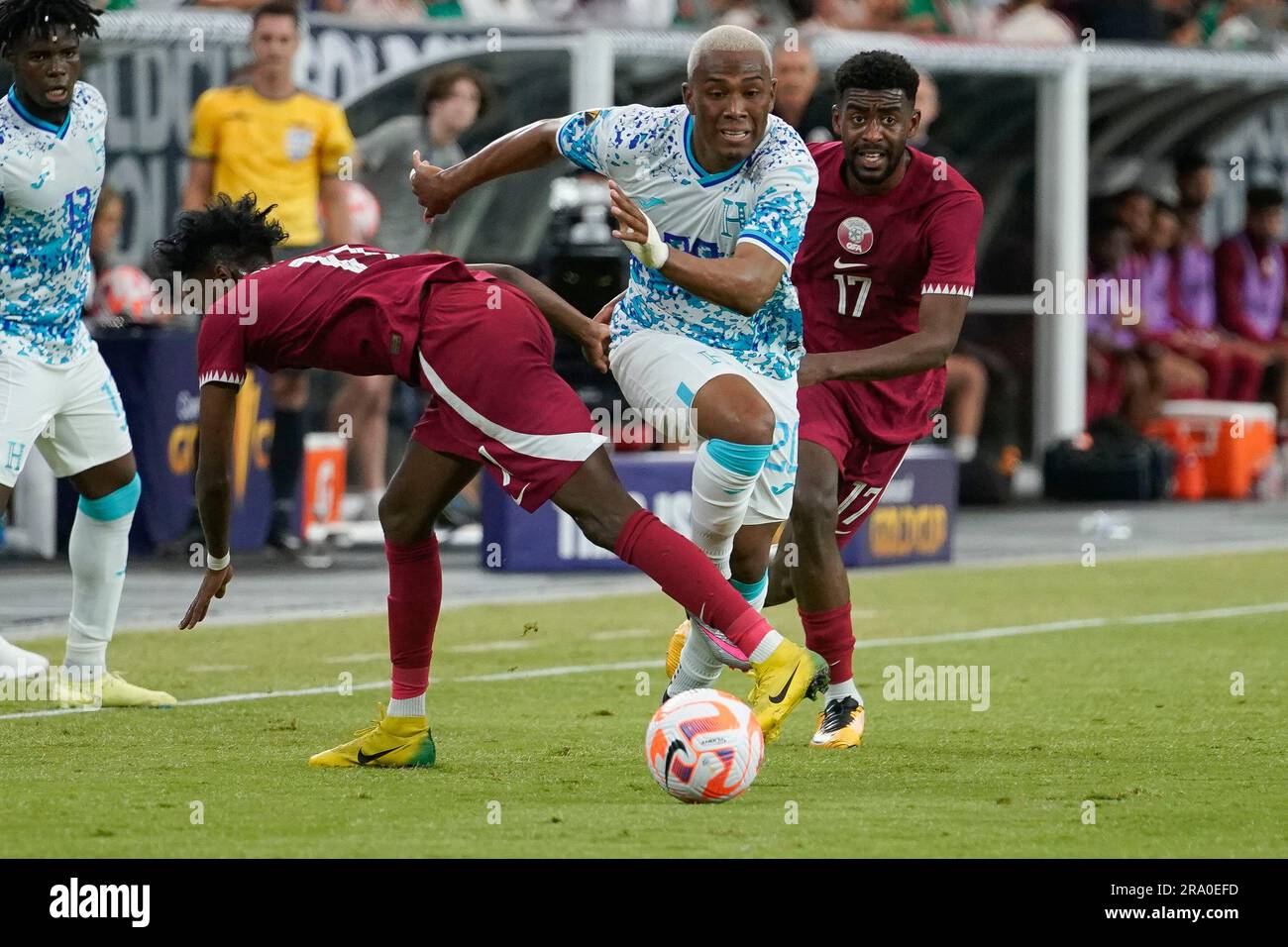 Honduras' Deybi Flores, middle gets tripped between Qatar's Yusuf ...