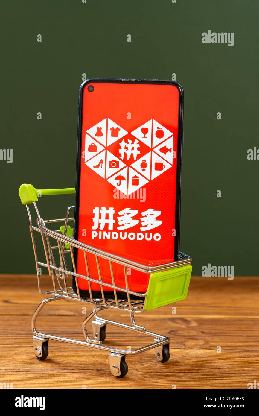 ZHONGSHAN China-June 27,2023:a mobile with PinDuoDuo logo in a shopping ...