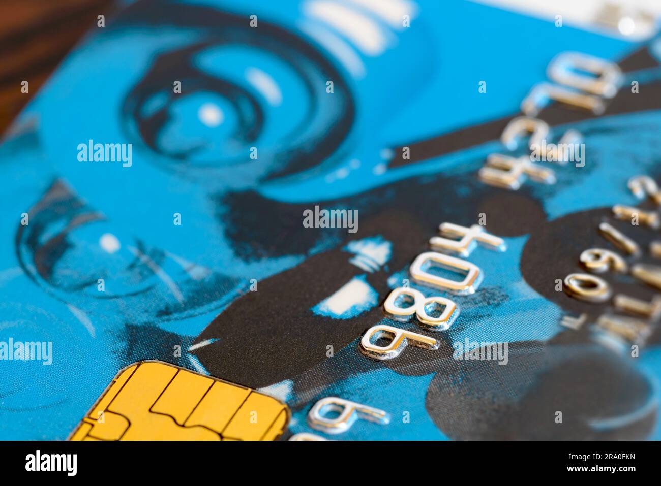 Macro detail of the numbers on a plastic credit card with golden ...