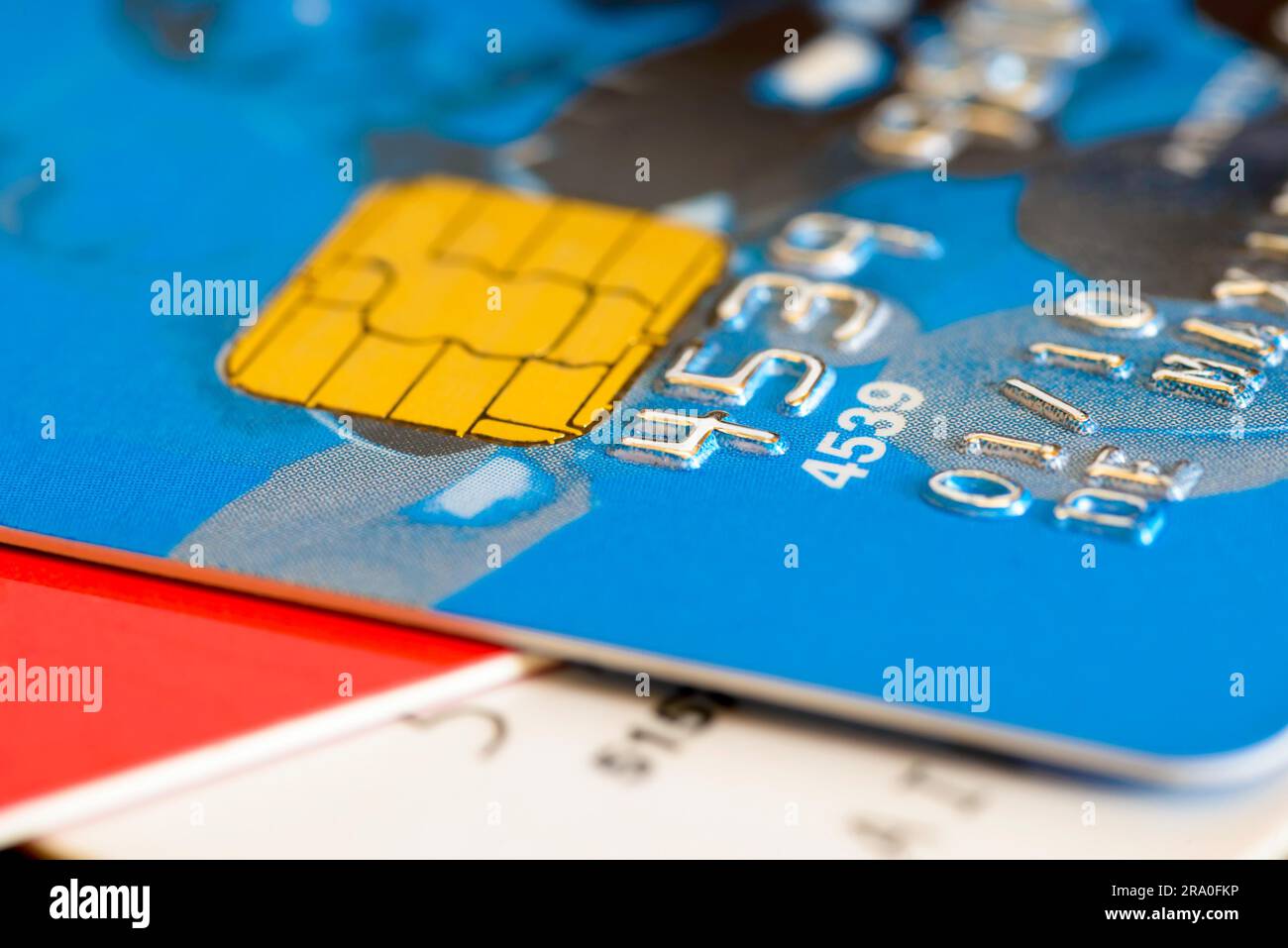 Macro detail of the numbers on a plastic credit card with golden ...