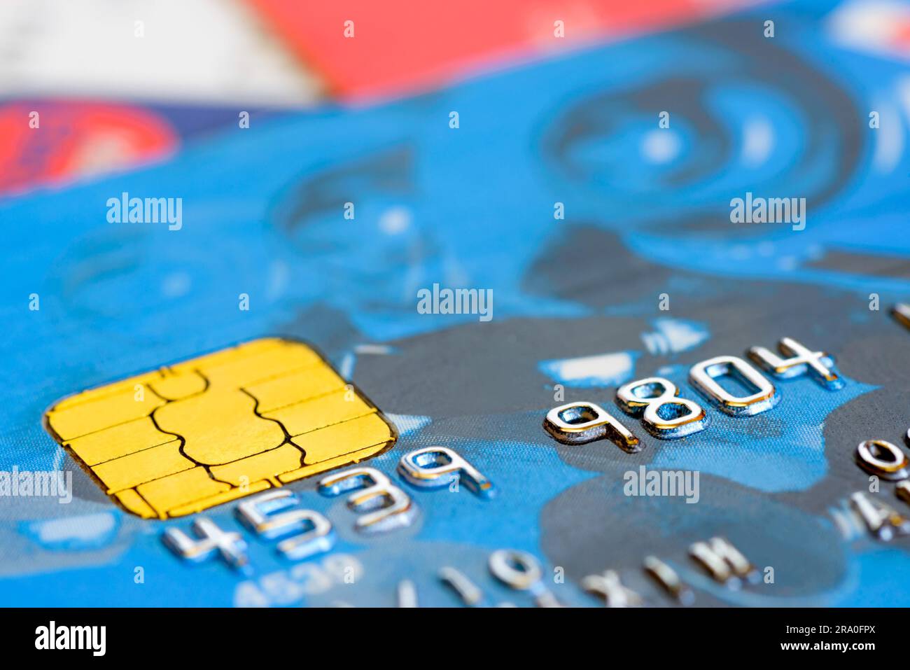 Macro detail of the numbers on a plastic credit card with golden ...
