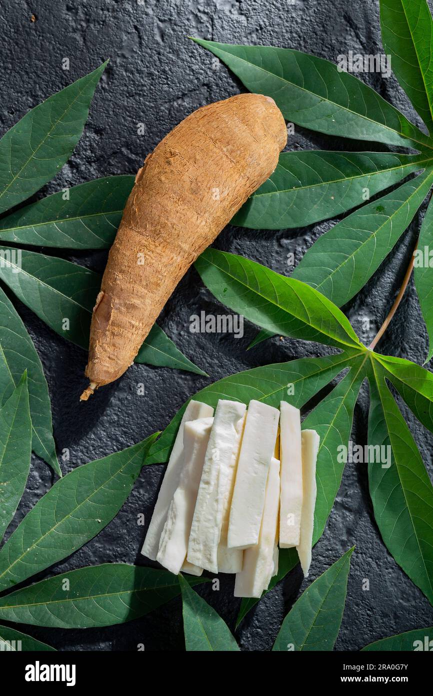 pile of cassava fruit and cassava flour on a background of rustic and ...