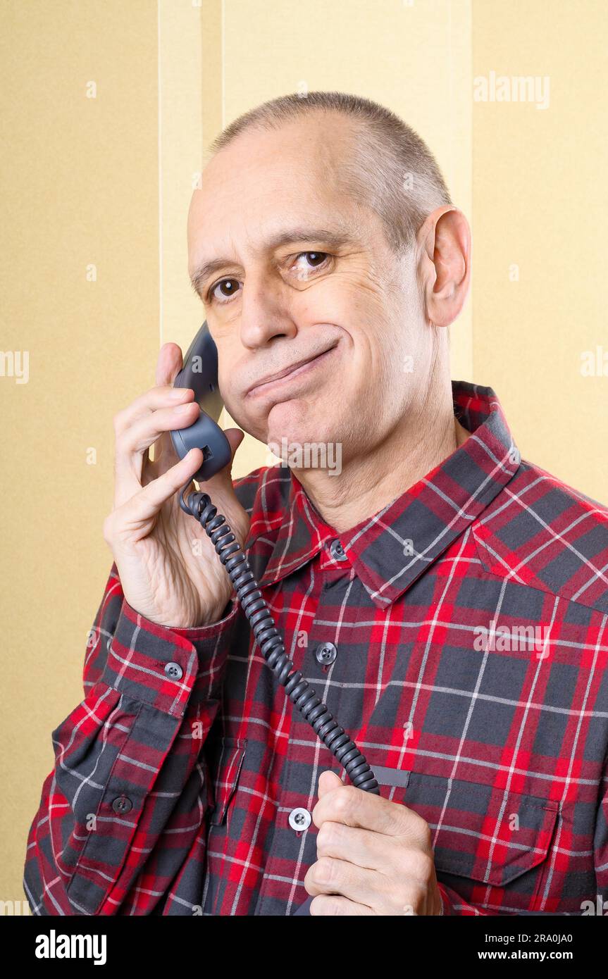 Annoyed man listening a boring conversation on phone Stock Photo - Alamy