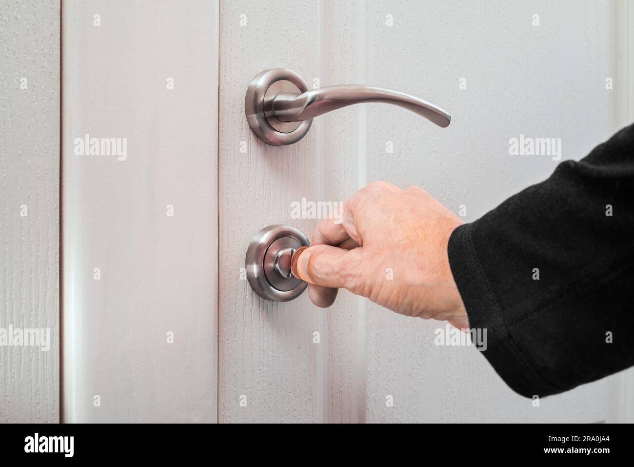 Opening or closing a safety lock on the toilet door Stock Photo - Alamy