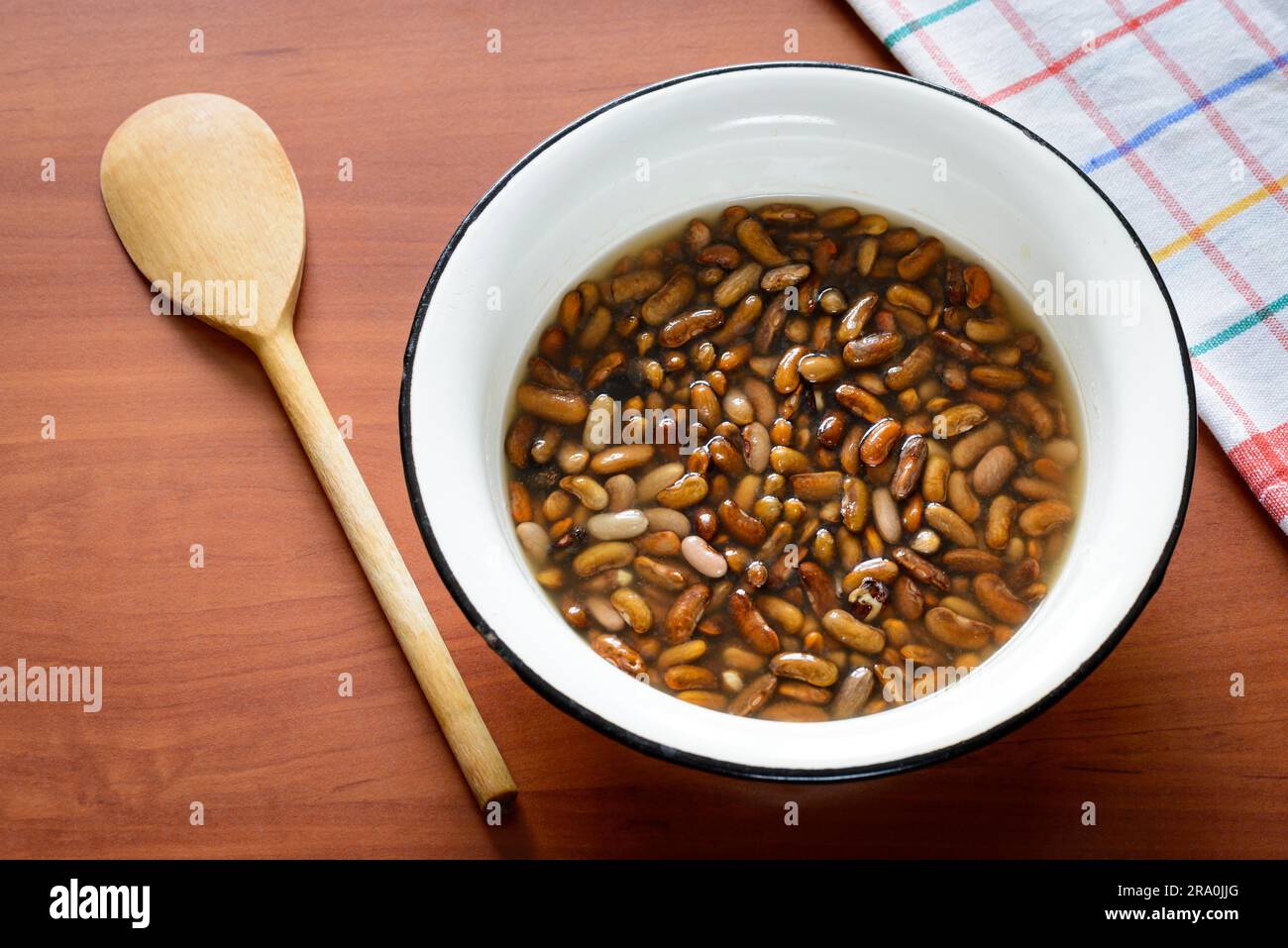 Brown beans soaking in water before to be cooked in a pot Stock Photo ...