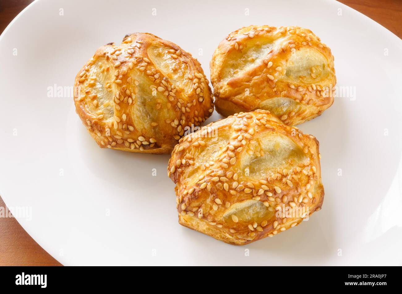 Three Puff with Chicken, Mushrooms and Sesame in a white porcelain ...