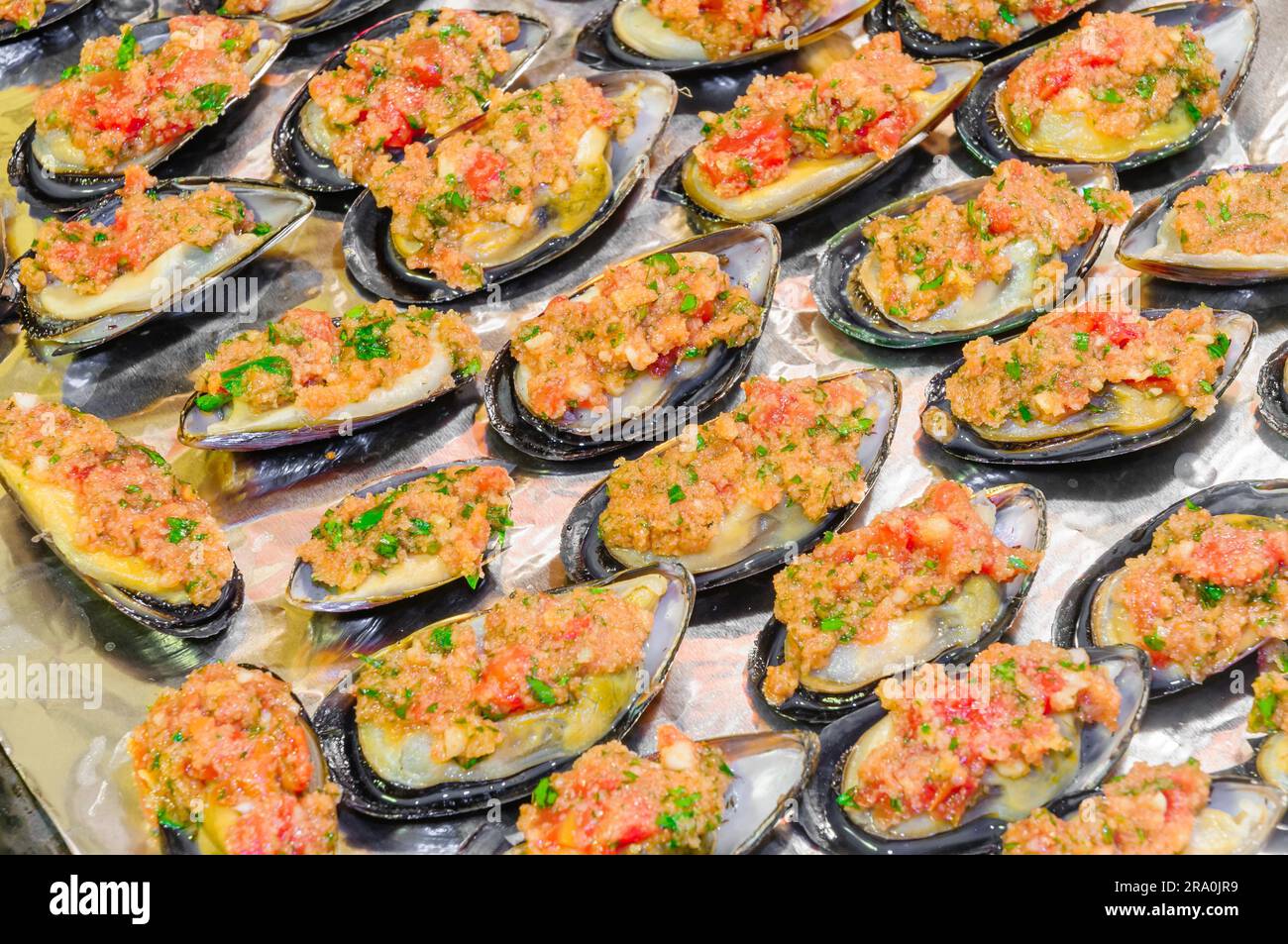Mussels Gratin preparation in a drip pan, ready to be cooked in oven ...