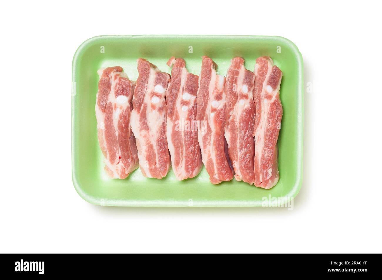 Pork ribs in a green foam tray, isolated on white background Stock ...