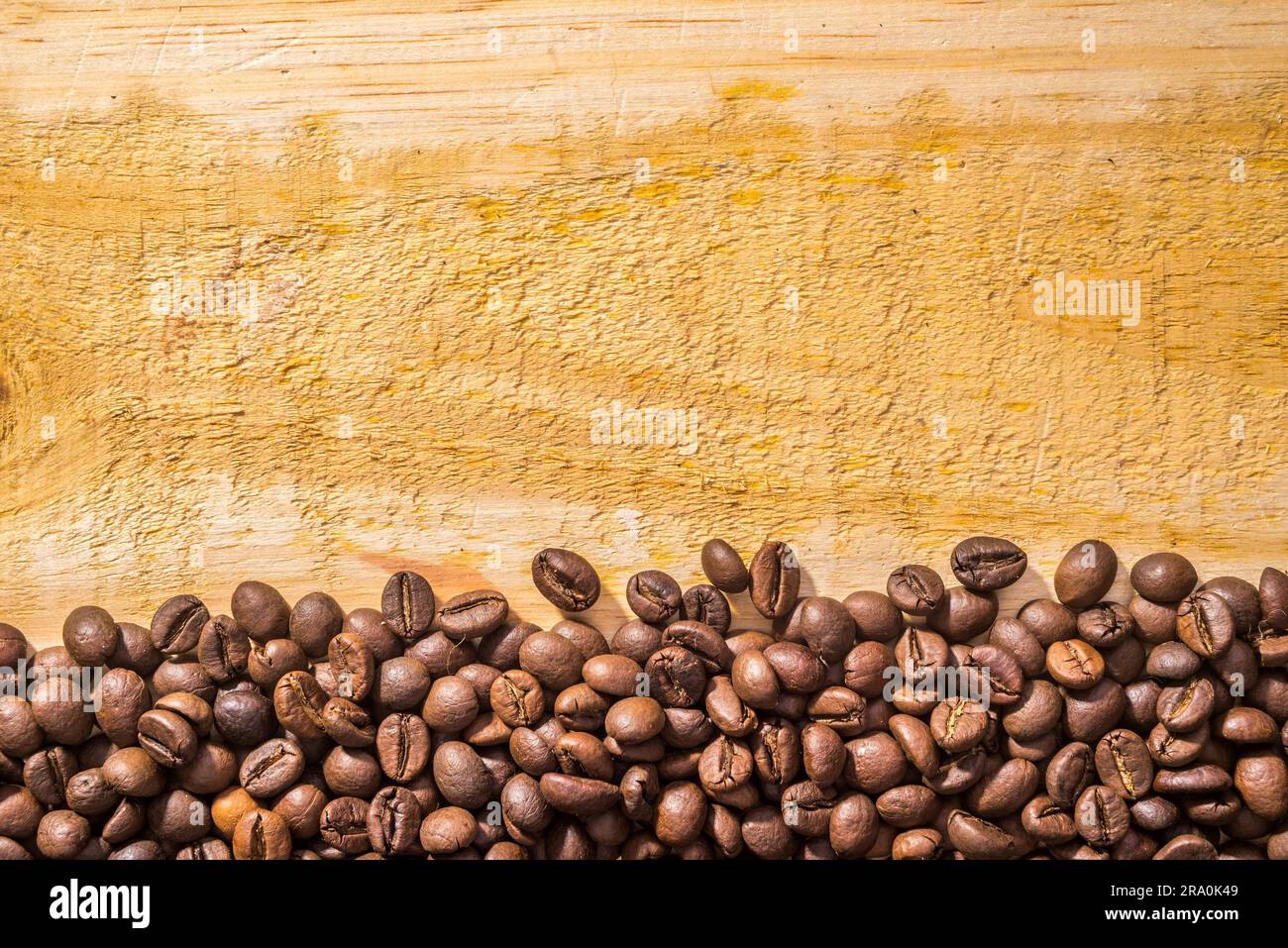 Background with coffee beans and light wood texture Stock Photo - Alamy