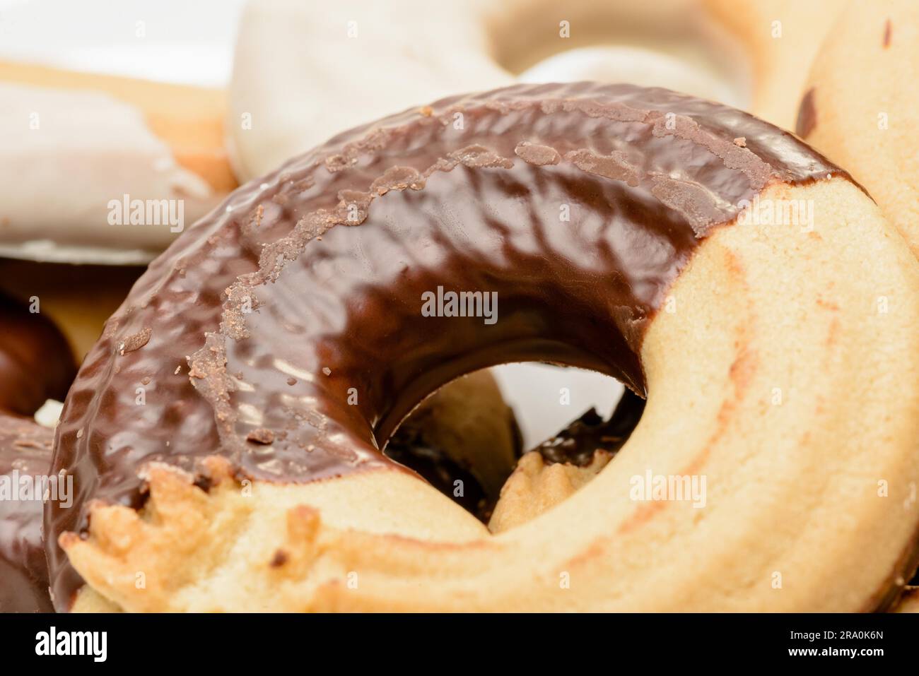 Macro of ring shaped chocolate biscuits in a porcelain plate isolated ...
