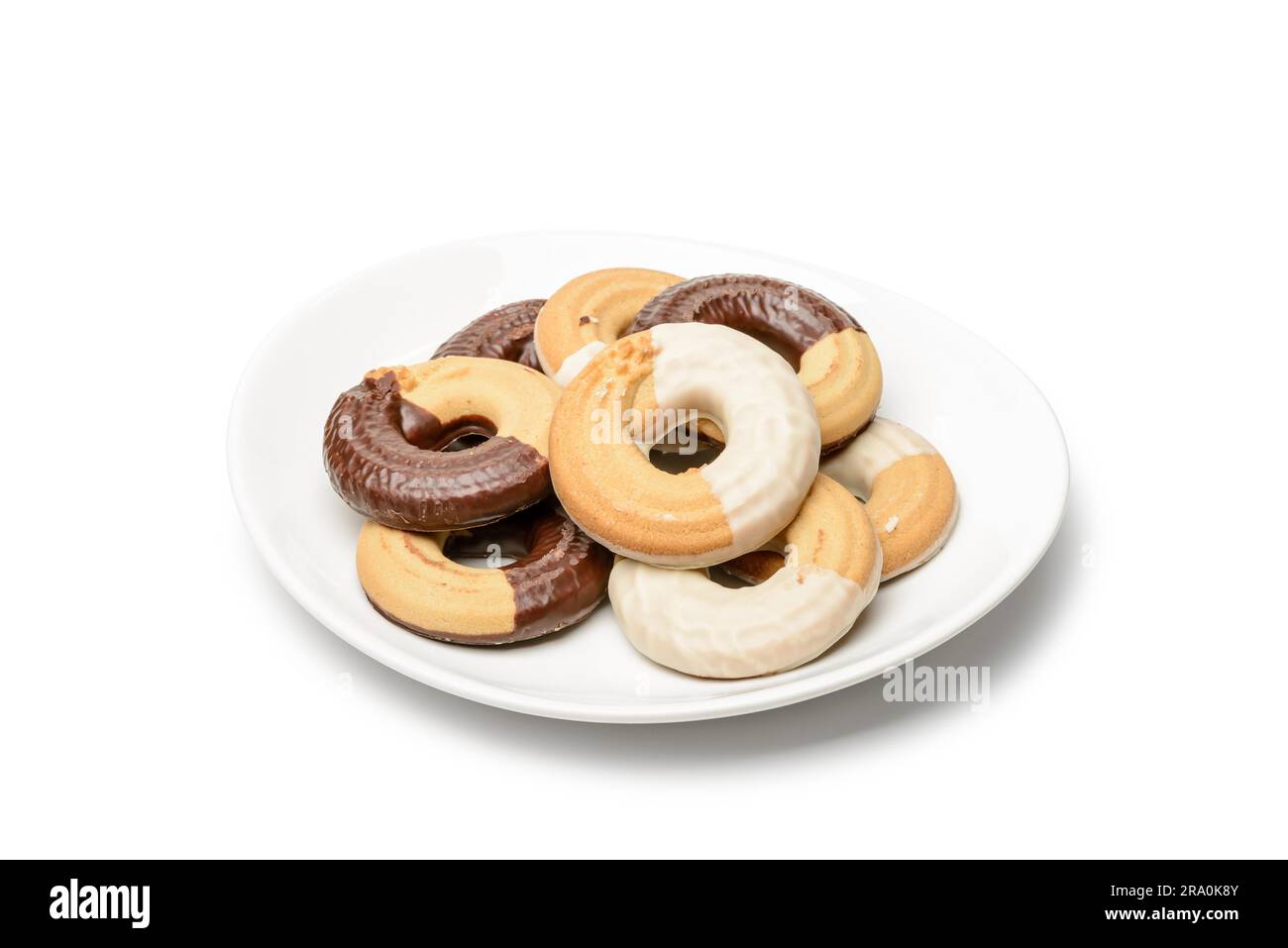 Ring shaped chocolate biscuits in a porcelain plate isolated on white ...