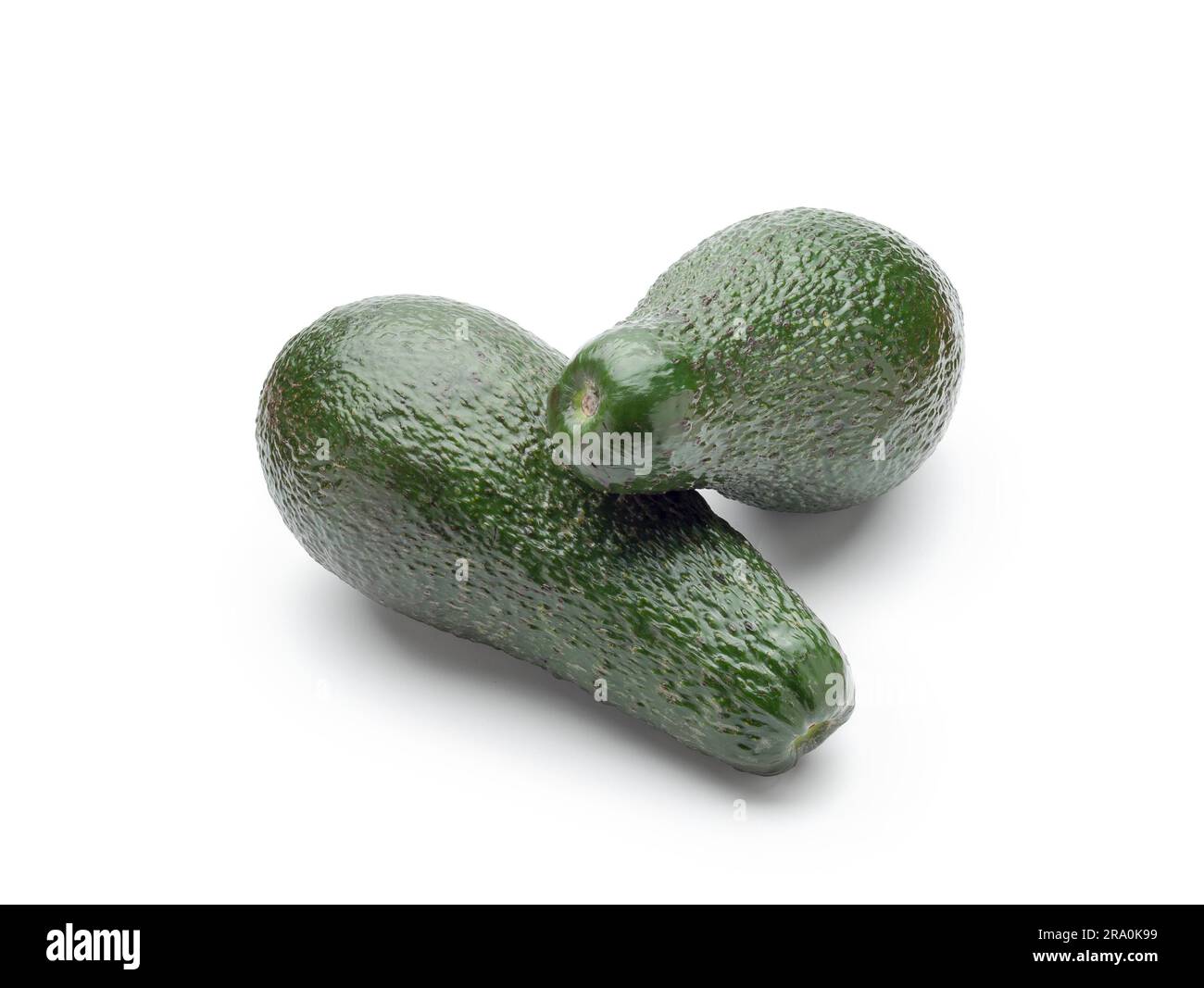 Two green avocados isolated on white background Stock Photo - Alamy