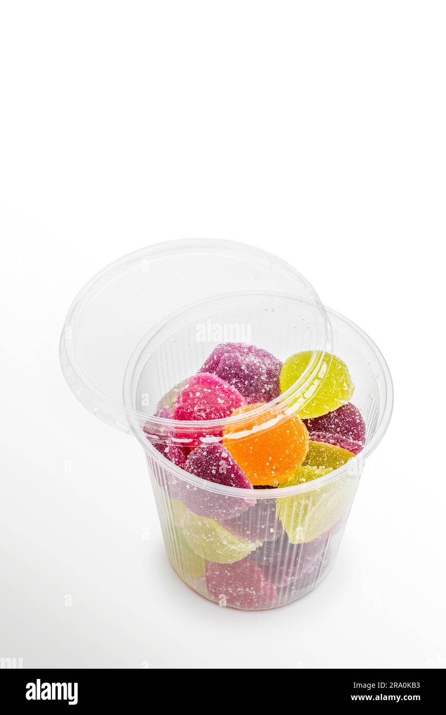 Colorful fruit jelly in open foam jar, on white background Stock Photo ...