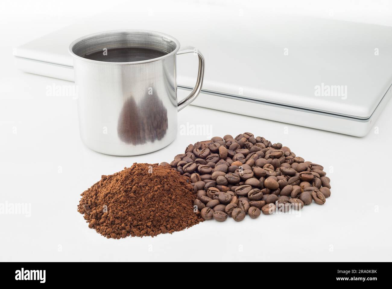 A warm metallic cup of coffee with coffee beans, instant soluble coffee ...