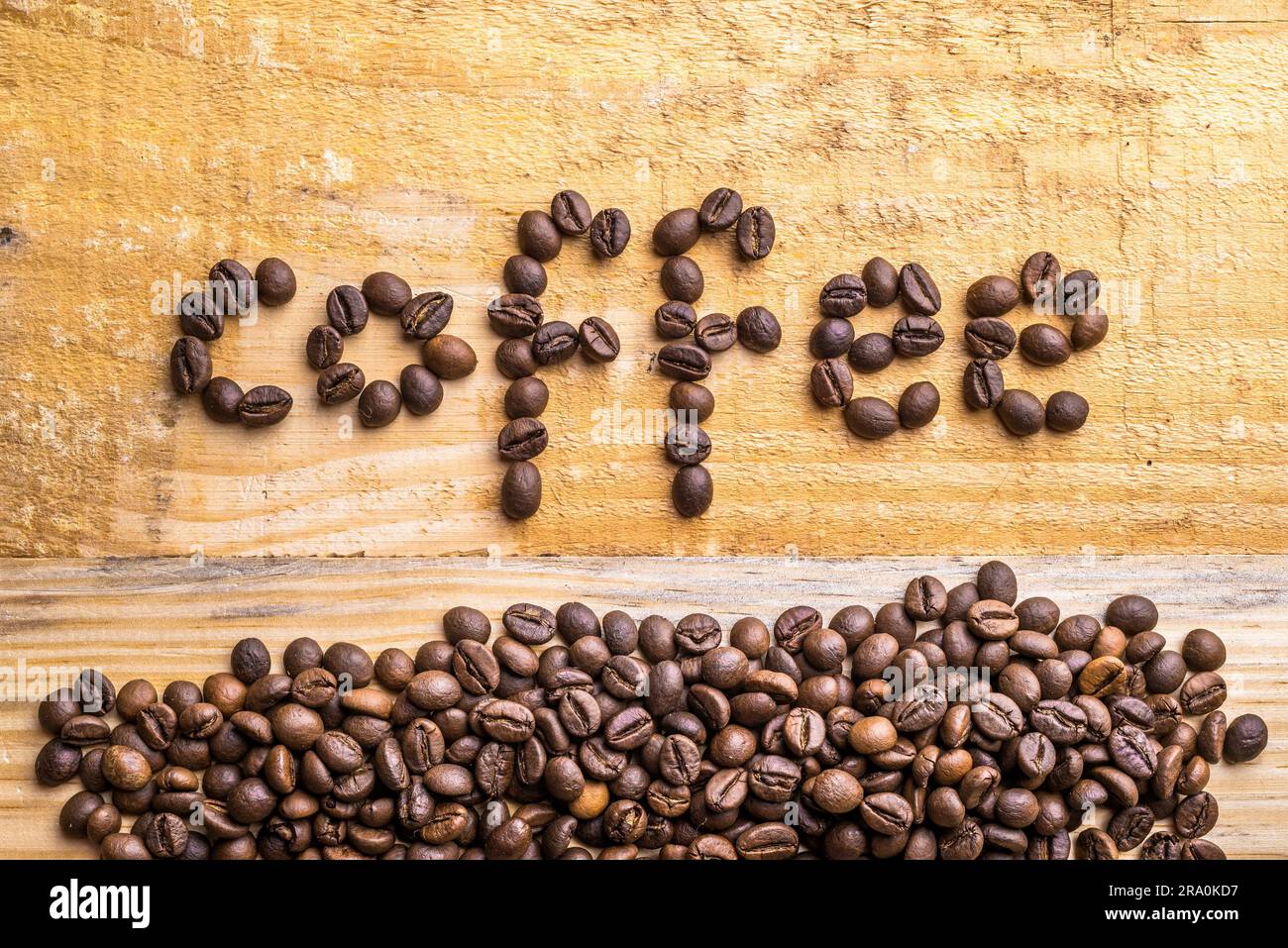 Light wood background texture with coffee beans writing the word Stock ...