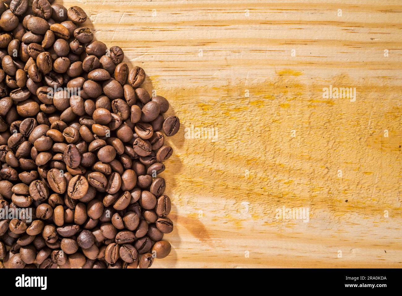 Background with coffee beans and light wood texture Stock Photo - Alamy
