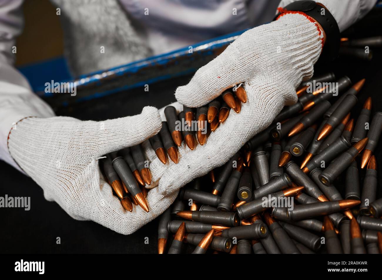 Sorting and selective quality control of weapon cartridges. Hands of ...