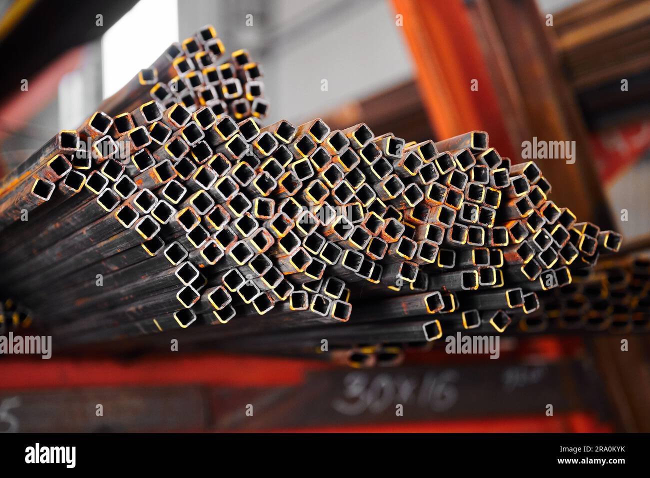 Square tubing pile on rack unit in cold factory warehouse Stock Photo ...