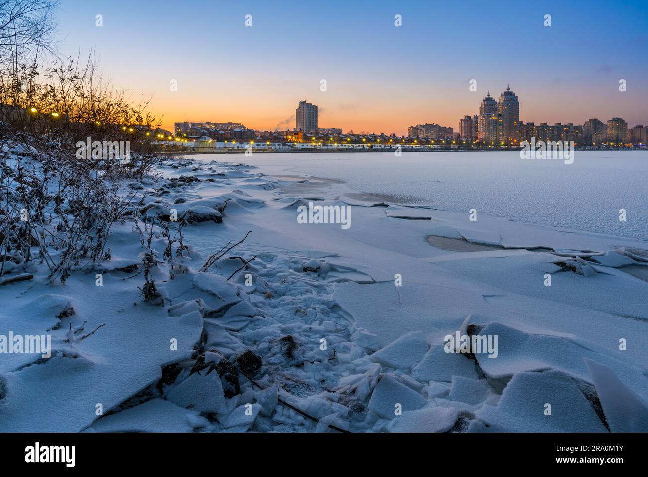 Cold Winter night cityscape with illuminated buildings in Kiev, Ukraine ...