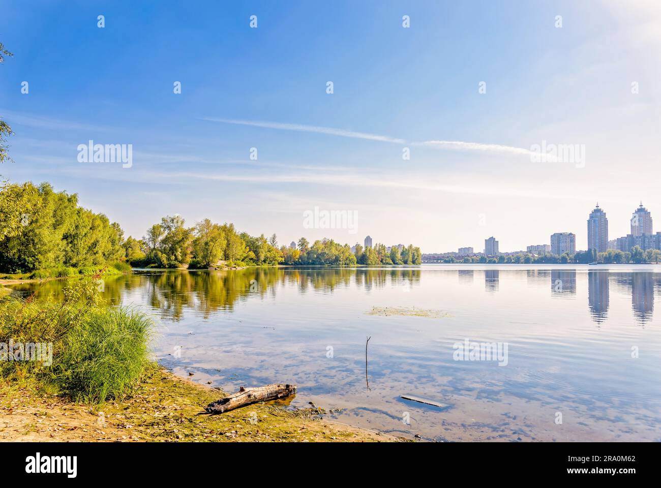 A quiet view of the river under the late summer sun, with the city ...