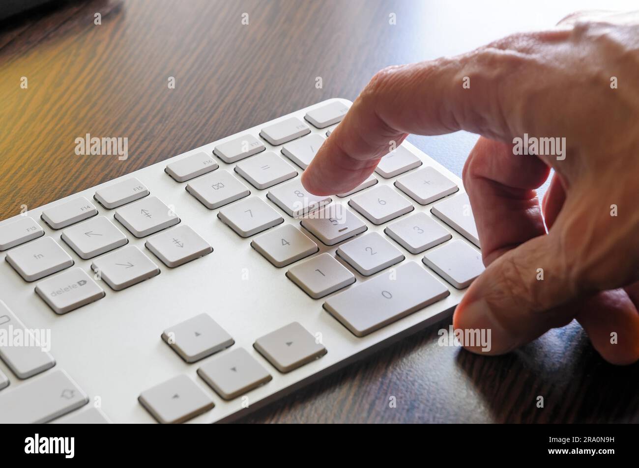 A senior man is using the numeric keyboard of his computer Stock Photo ... A senior man is using the numeric keyboard of his computer Stock Photo ...