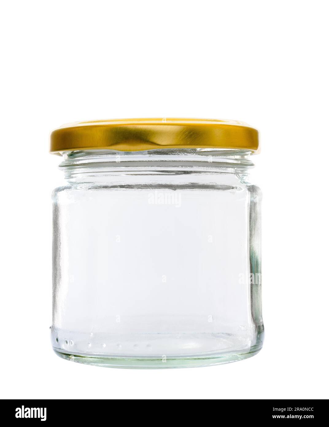Transparent glass jar on white background, with the closed gold color ...