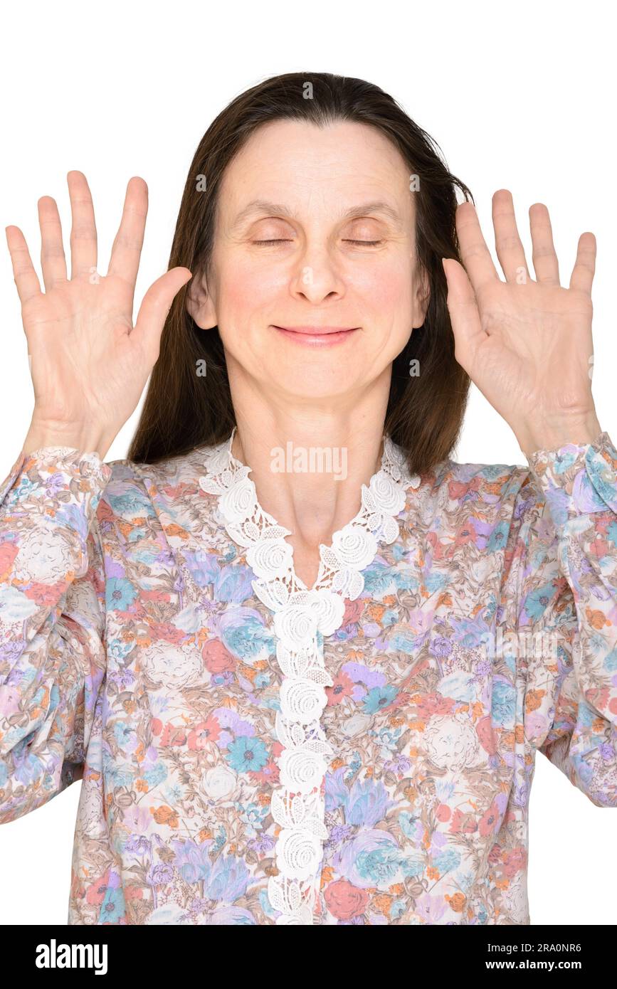 Smiling woman with closed eyes and open hands up showing the palms ...
