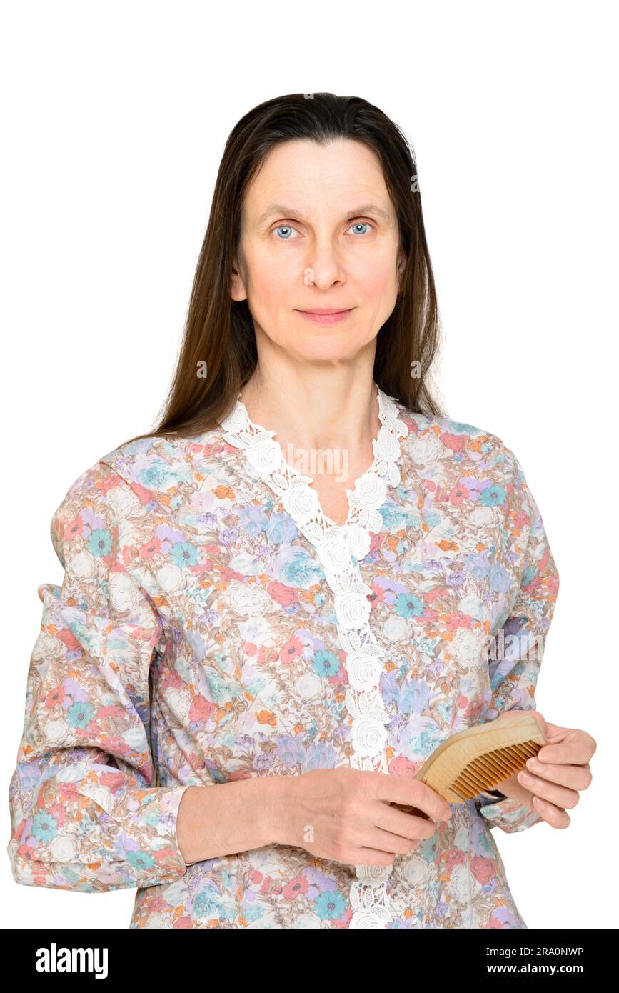 Adult woman combing long brown hair with a wooden comb, isolated on ...
