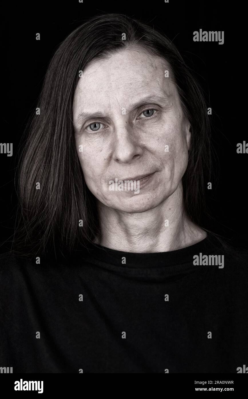 Portrait of a sad and depressed adult woman looking into space with ...